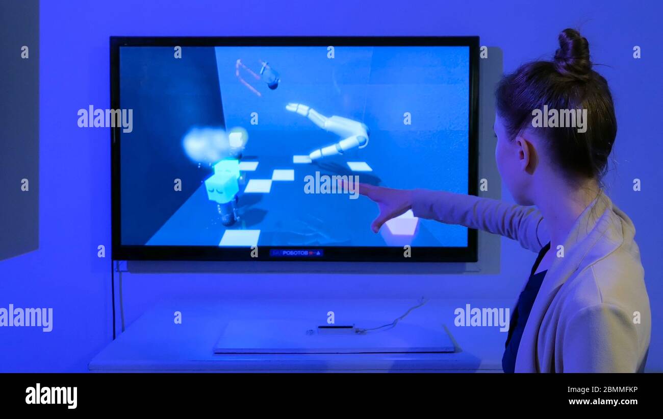 MOSCOW, RUSSIA - July 30, 2018: Robostation - future exhibition. Woman ...