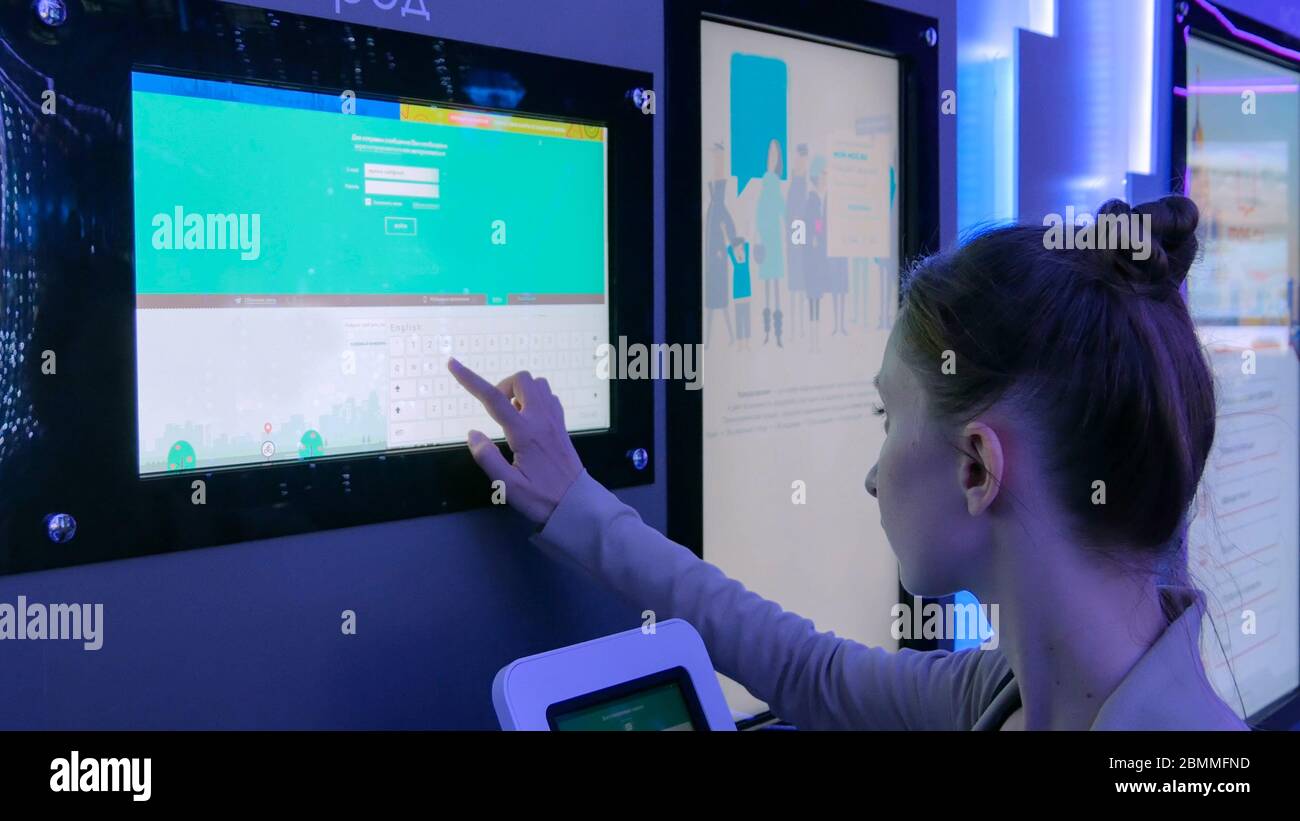 MOSCOW, RUSSIA - July 30, 2018: Smart City Exhibition. Woman using ...