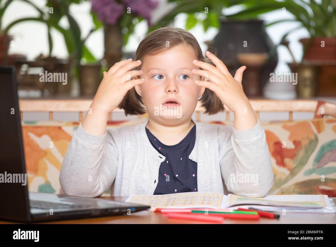 Distance learning-online education. School girl watching online ...