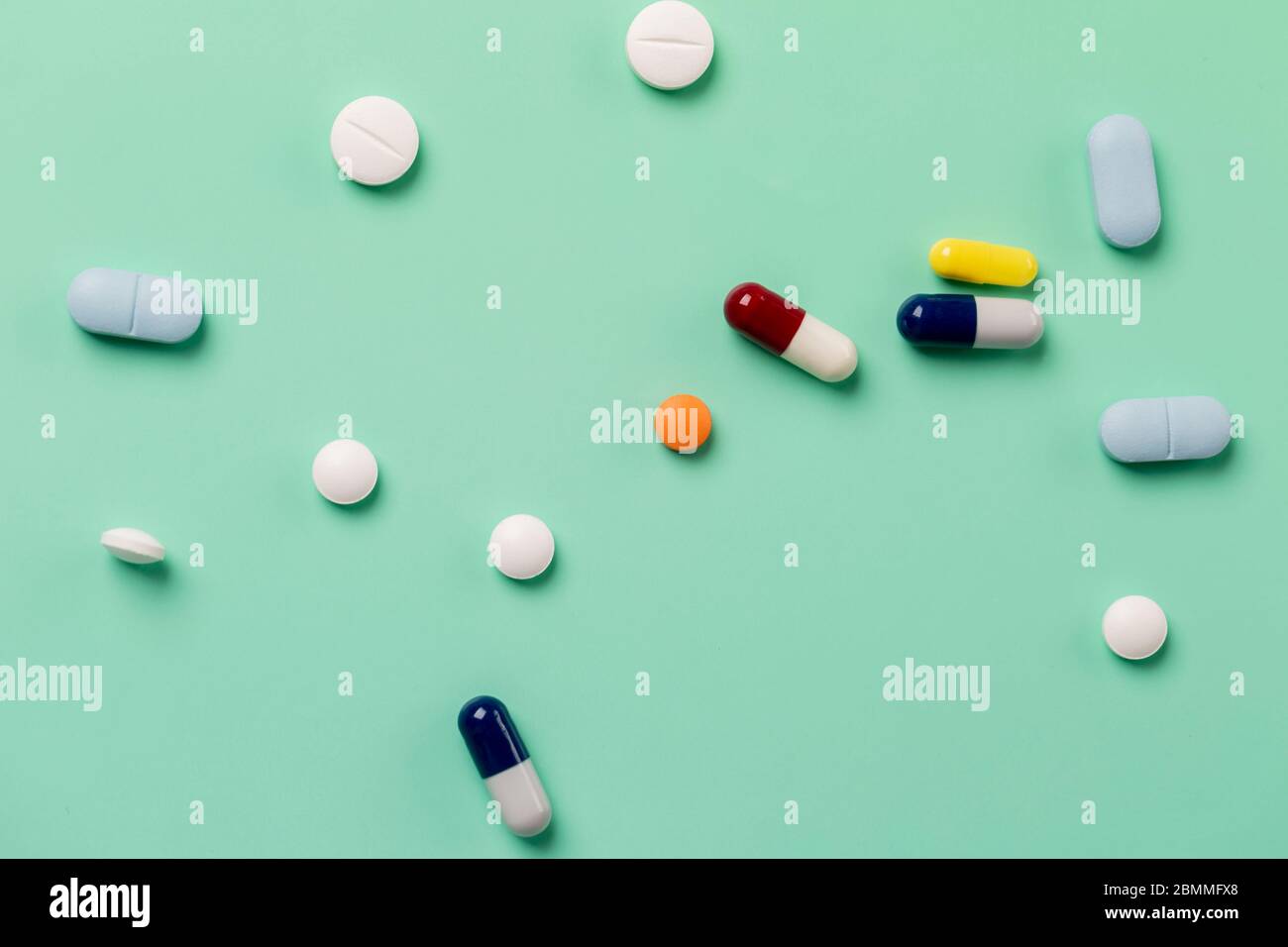 Different medications. Green backdrop Stock Photo - Alamy
