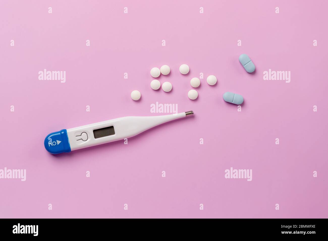 Different medications. Digital thermometer. One-color backdrop Stock ...