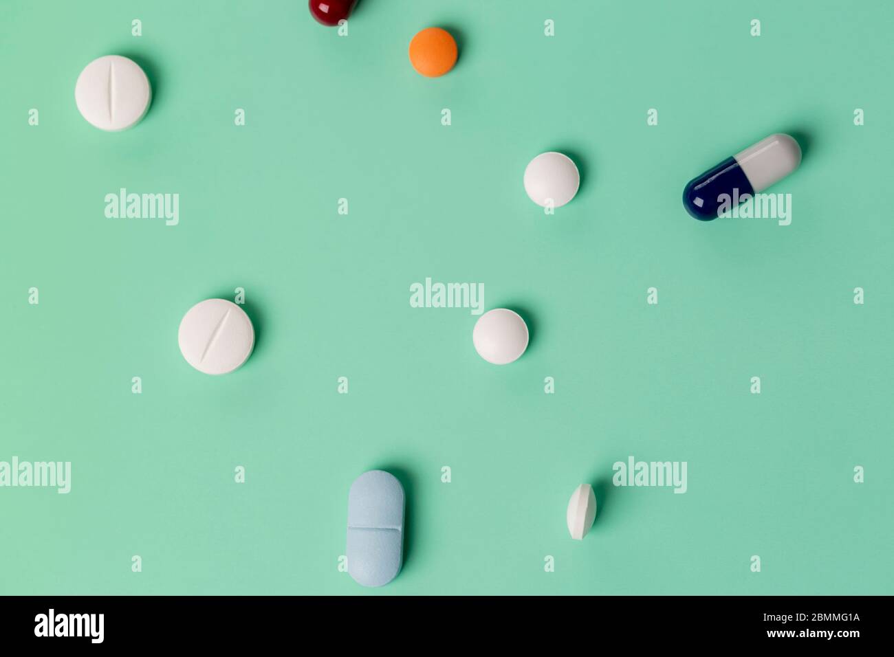 Different medications. Green backdrop Stock Photo - Alamy