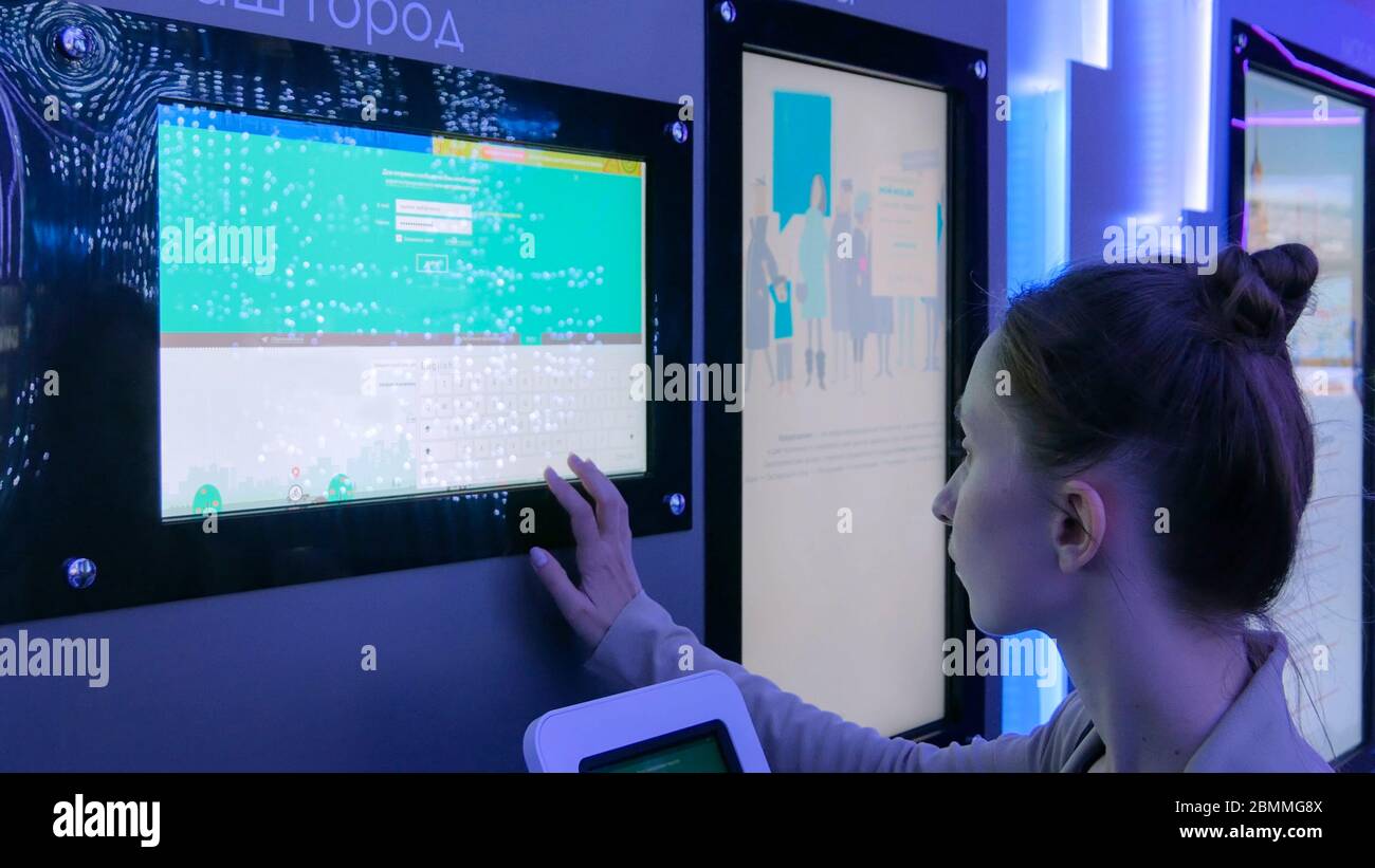 MOSCOW, RUSSIA - July 30, 2018: Smart City Exhibition. Woman using ...