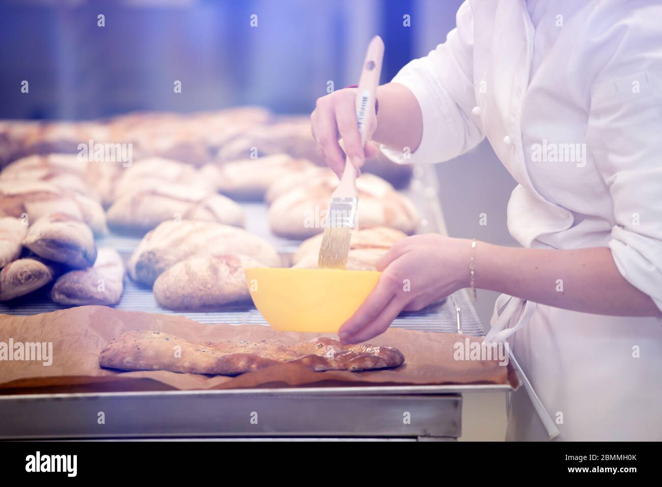 Baker working in bakery making tradition french bread and pastry Stock ...