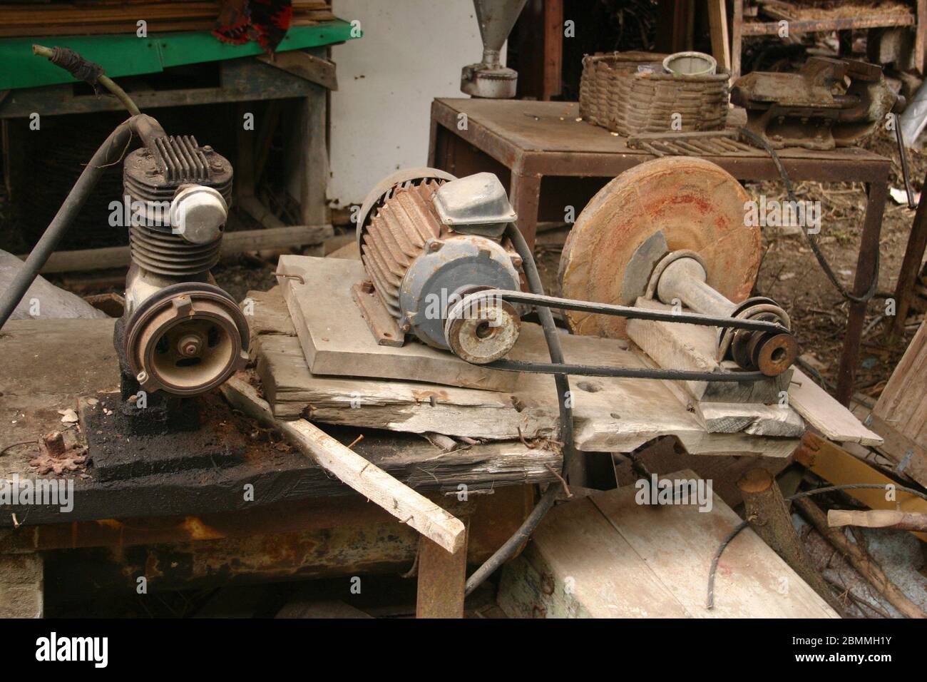 Old grinder in a messy yard Stock Photo - Alamy
