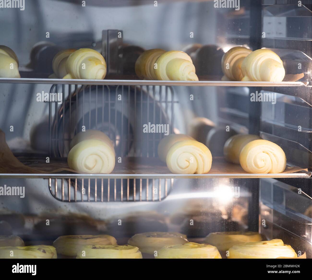 Baking pastry in a professional oven in a bakery Stock Photo - Alamy