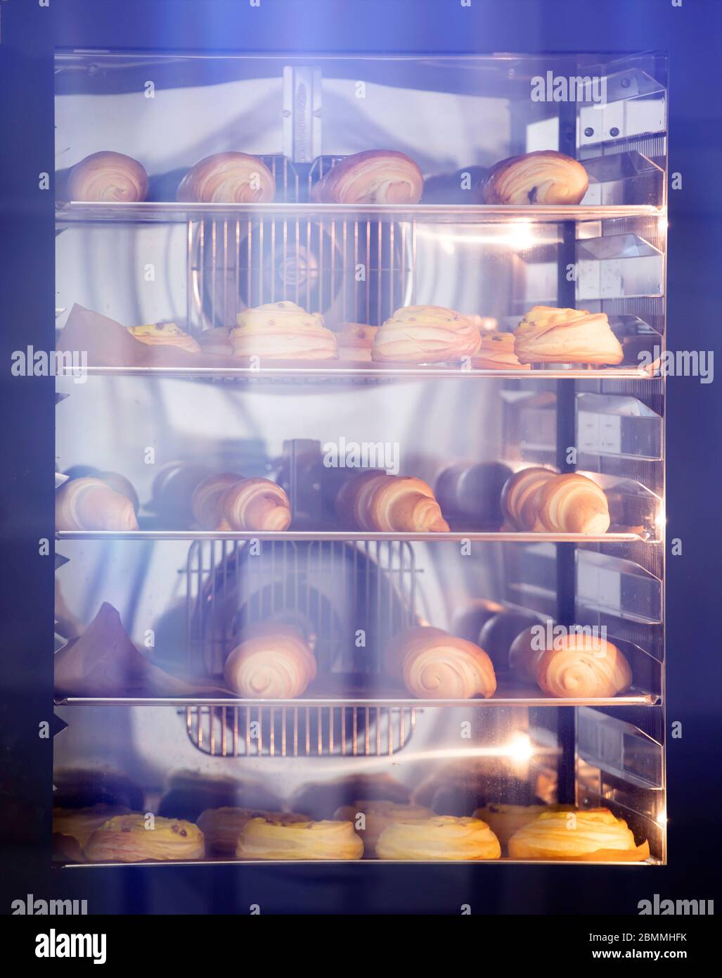 Baking pastry in a professional oven in a bakery Stock Photo - Alamy