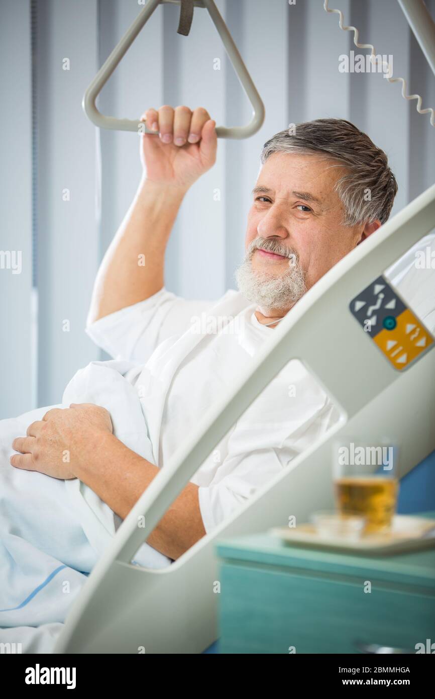 Senior male patient in a modern hospital. Getting better after a ...