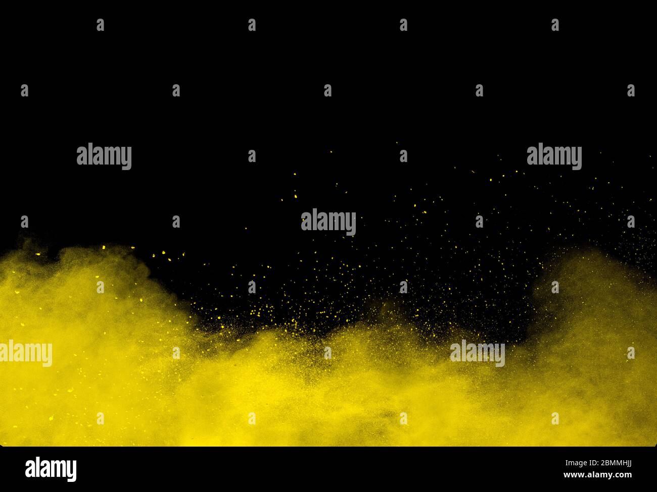 Yellow color powder explosion on black background Stock Photo - Alamy