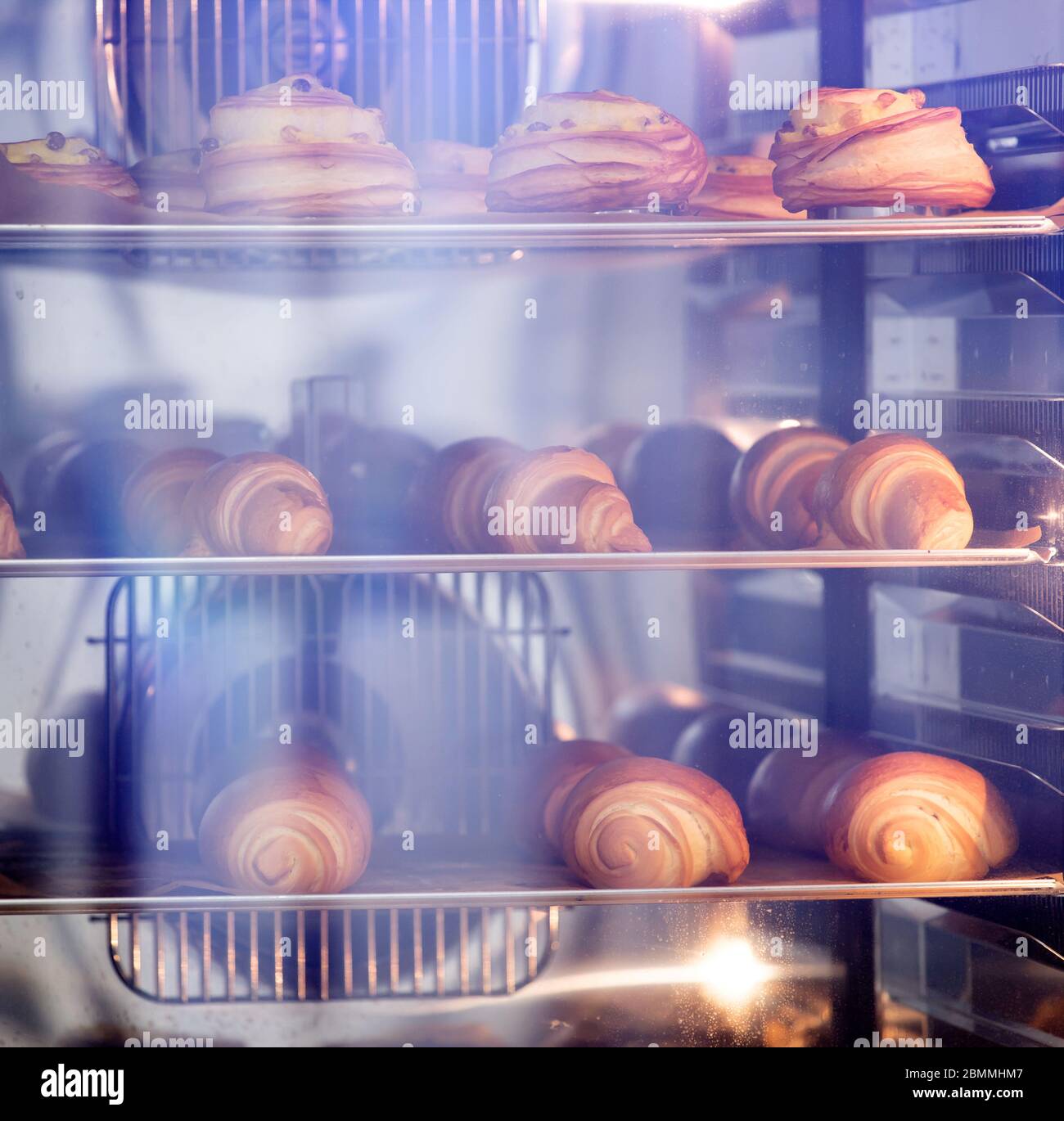 Baking pastry in a professional oven in a bakery Stock Photo - Alamy