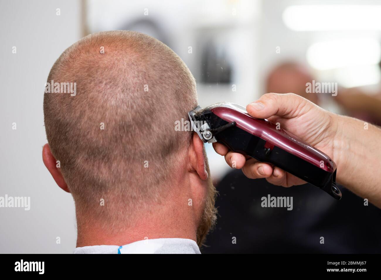 Man being trimmed with professional electric clipper machine in ...