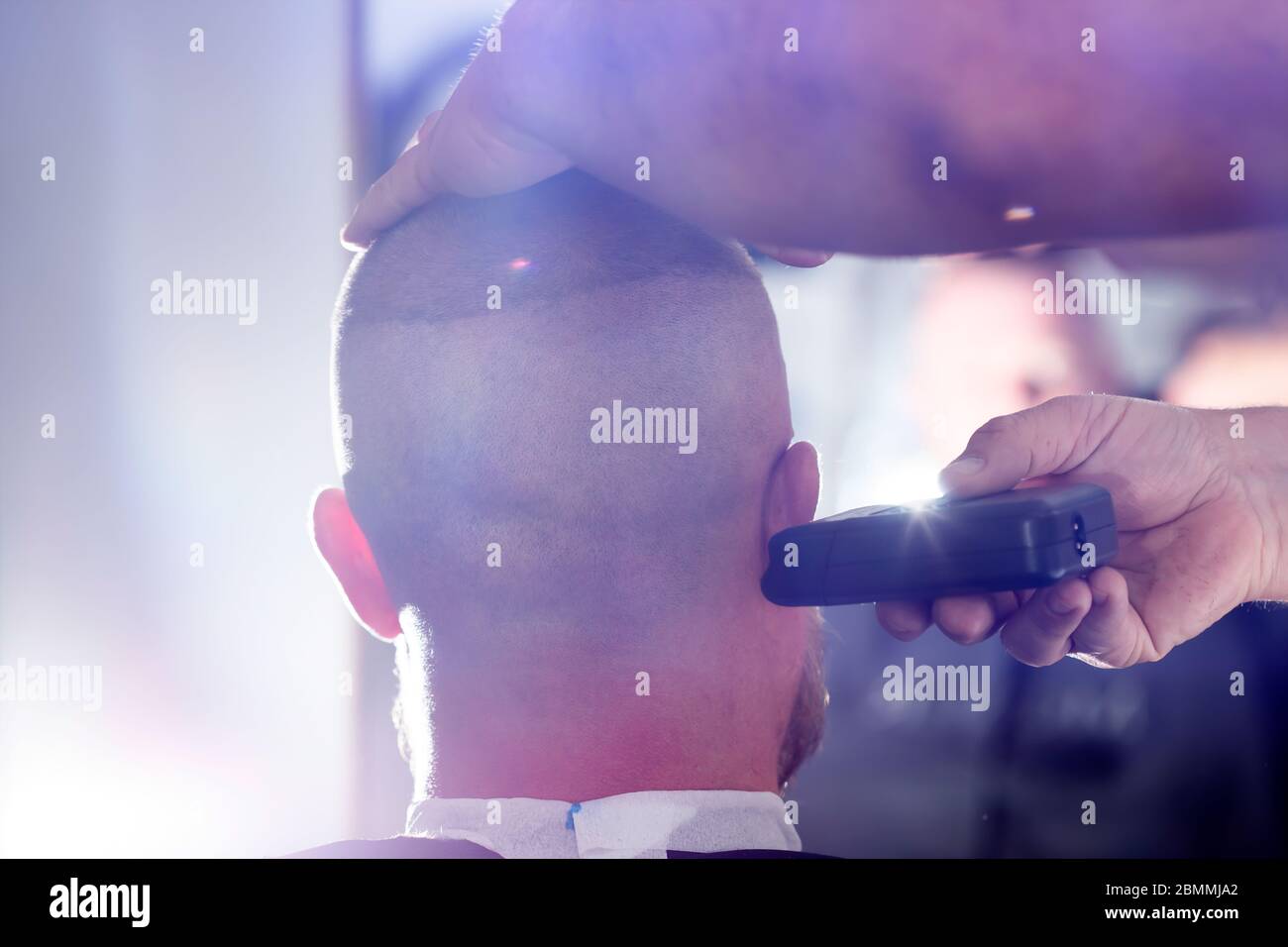 Man being trimmed with professional electric clipper machine in ...