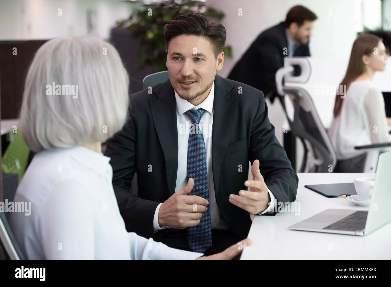 Colleagues discussing task working on new project in coworking office ...