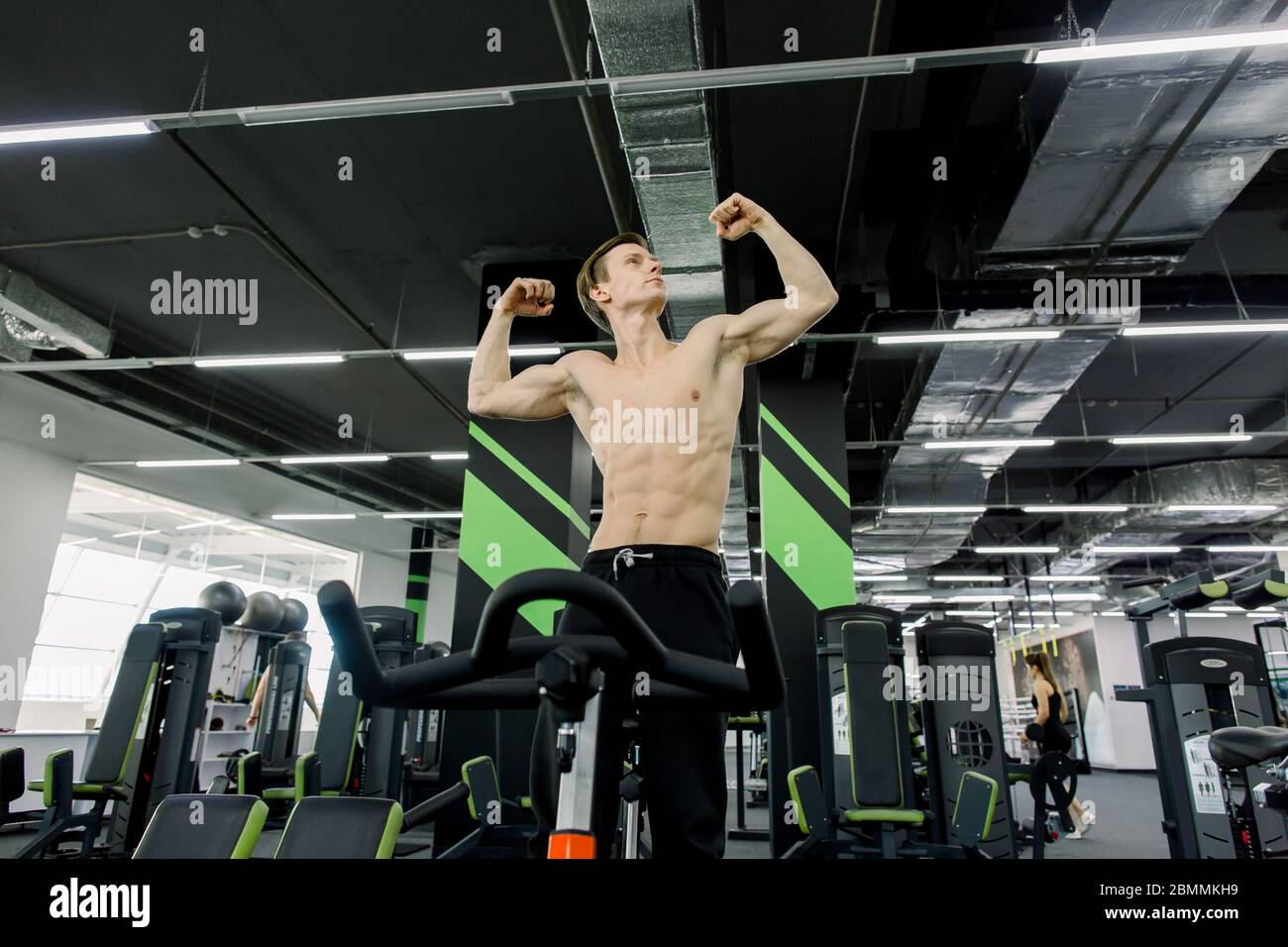 Healthy lifestyle concept. Young sporty man without shirt is exercising ...