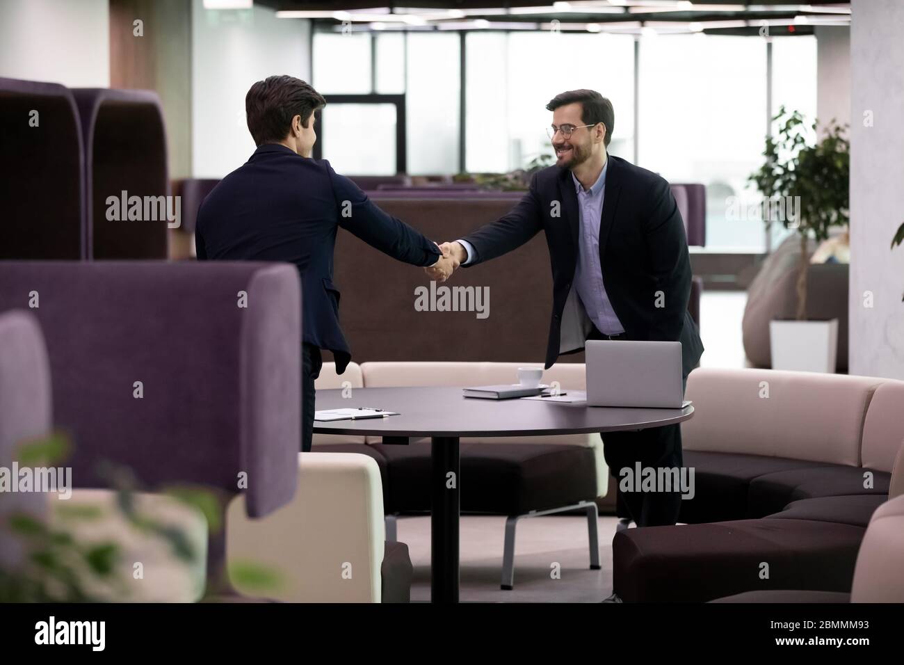 Two businessmen at meeting shake hands express respect Stock Photo - Alamy