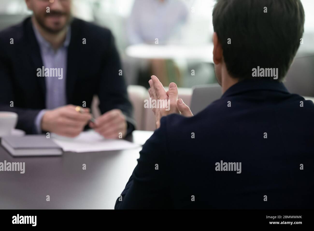 Back view applicant communicating with HR manager passing job interview ...