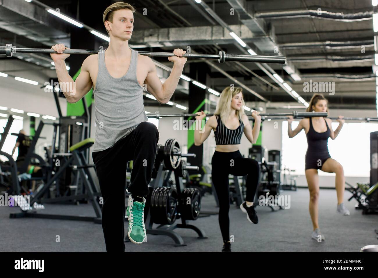 sport, bodybuilding, lifestyle and people concept - young man and two ...