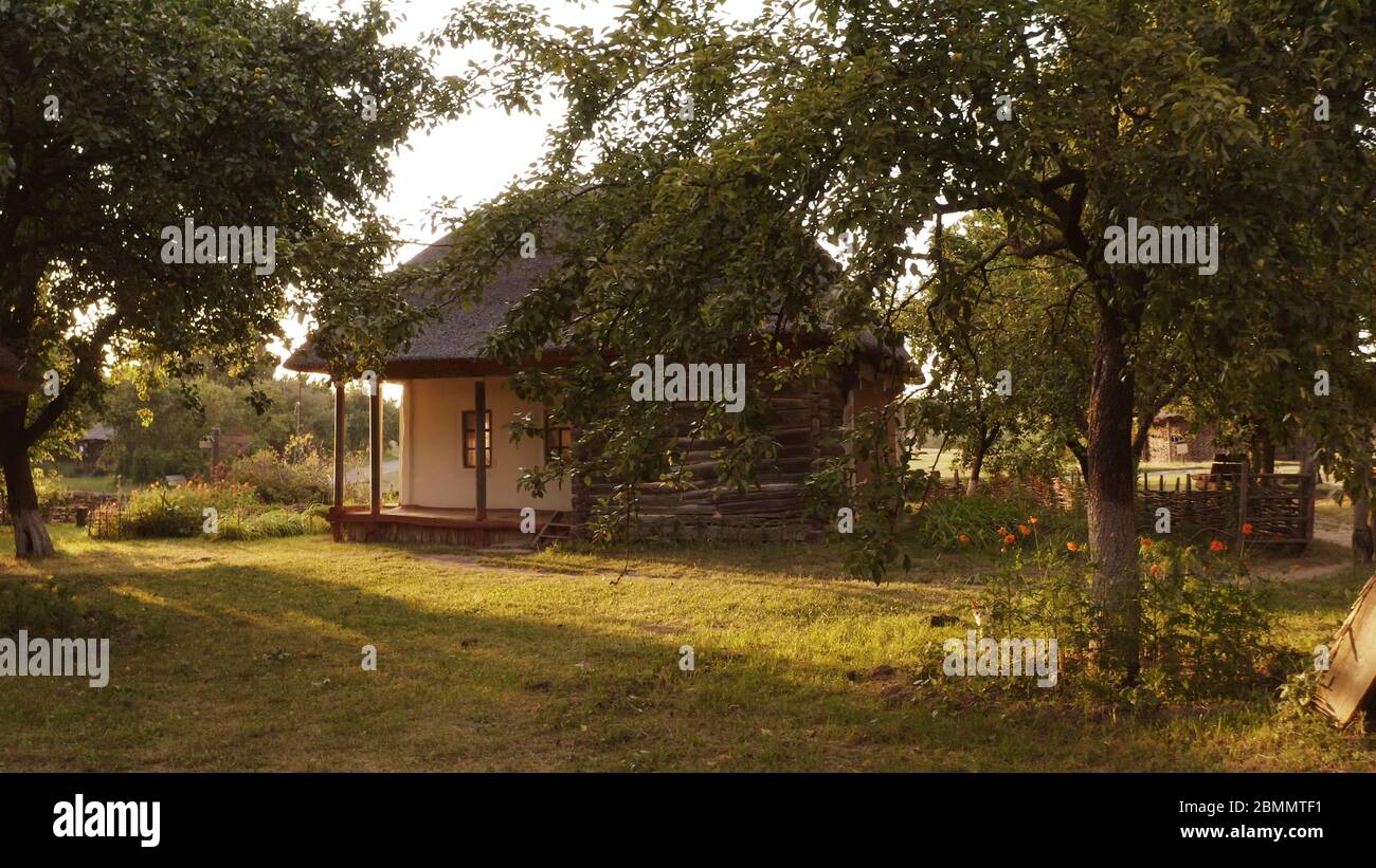Small village house behind the green trees Stock Photo - Alamy