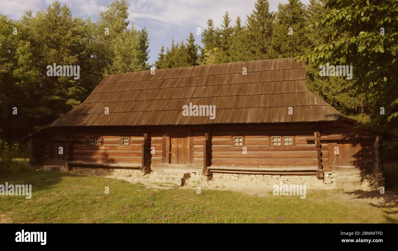 Long log house is surrounded by trees Stock Photo - Alamy