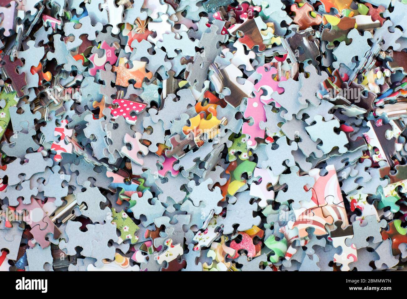 Puzzle pieces mixed in a box Stock Photo - Alamy