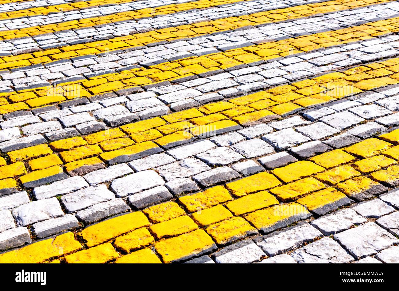 Pedestrian crossing with white and yellow stripes as background ...