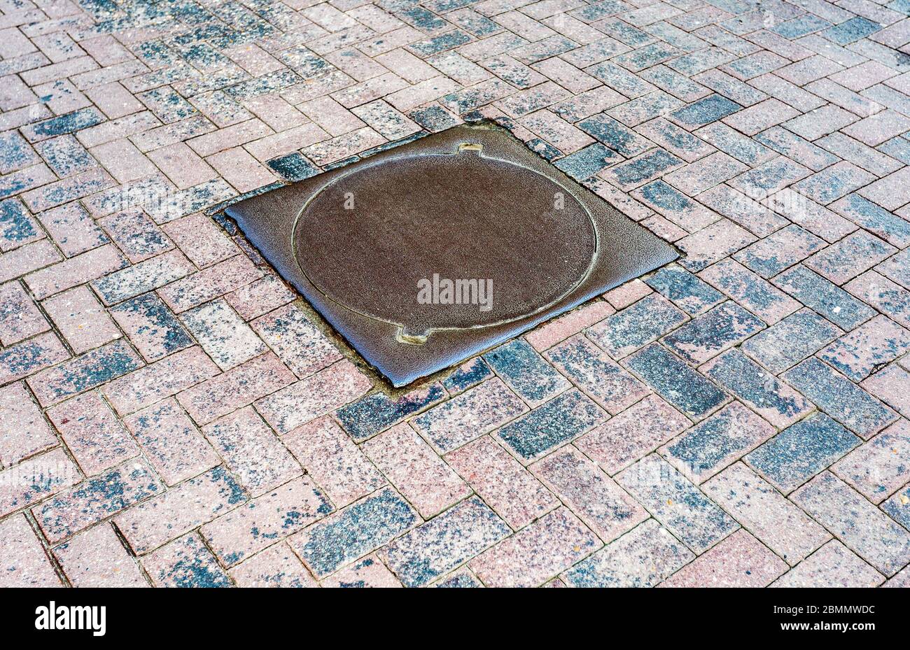 Rusty metal manhole cover on urban pavement road Stock Photo - Alamy