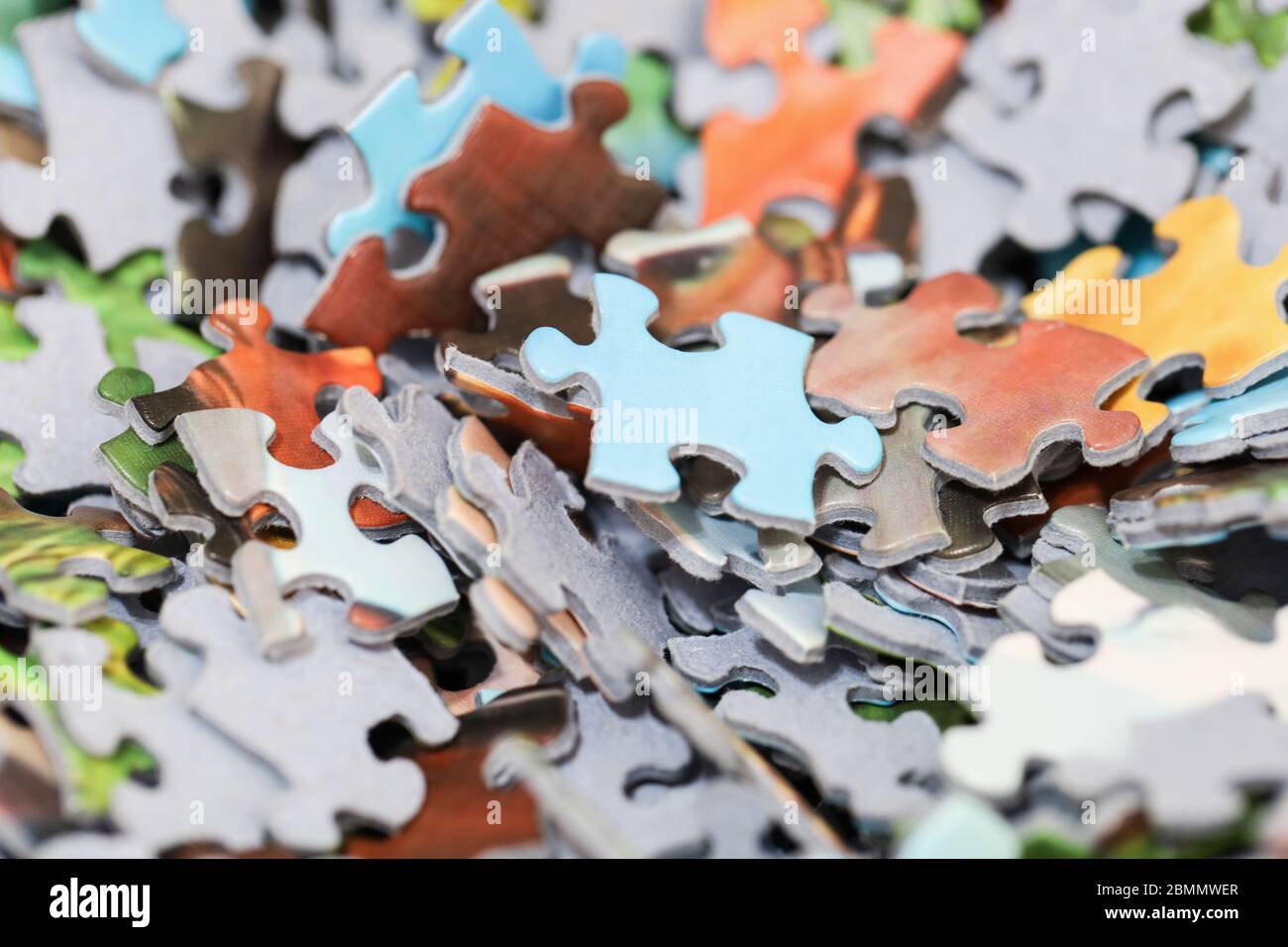 Puzzle pieces mixed in a box Stock Photo - Alamy