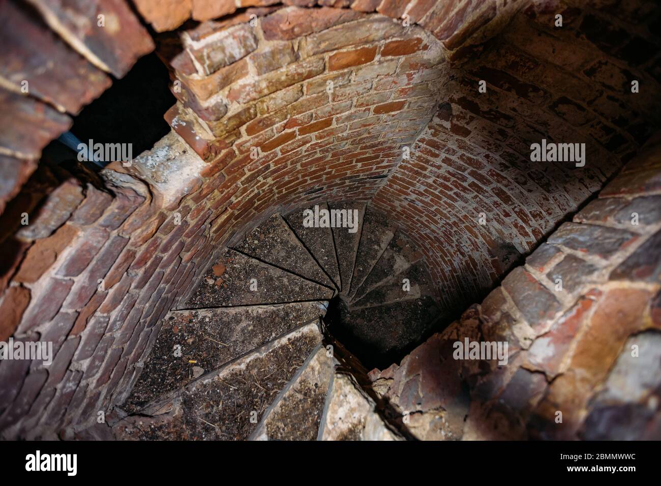 Old spiral staircase inside red brick tower, upside view Stock Photo ...