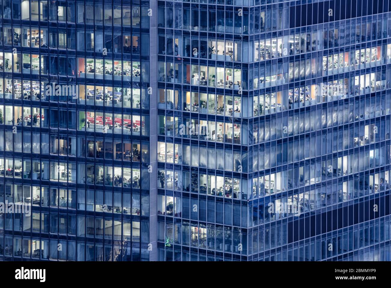 Working late. Office windows by night Stock Photo - Alamy