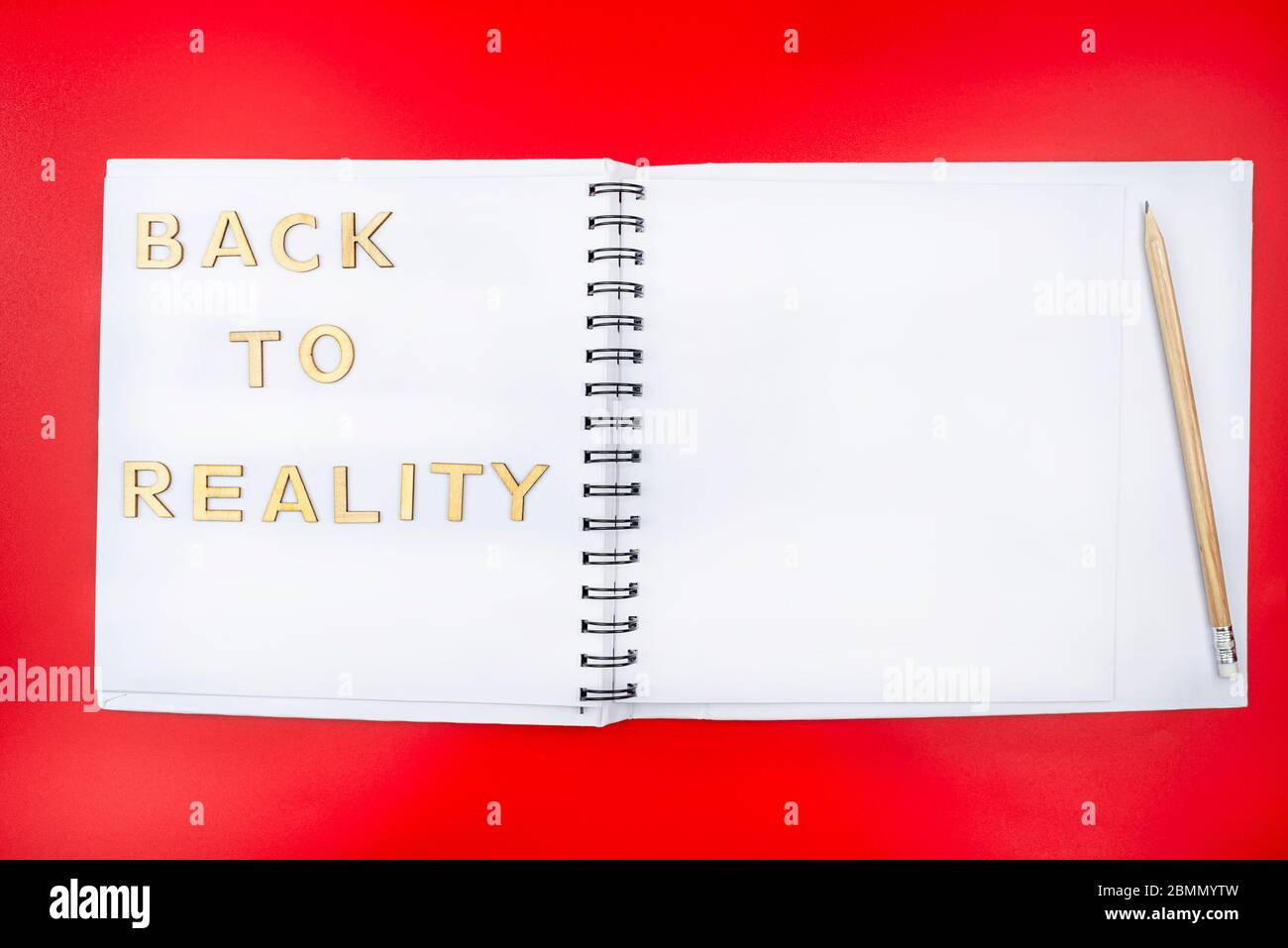 The inscription "back to reality" made of wooden letters lying on an ...