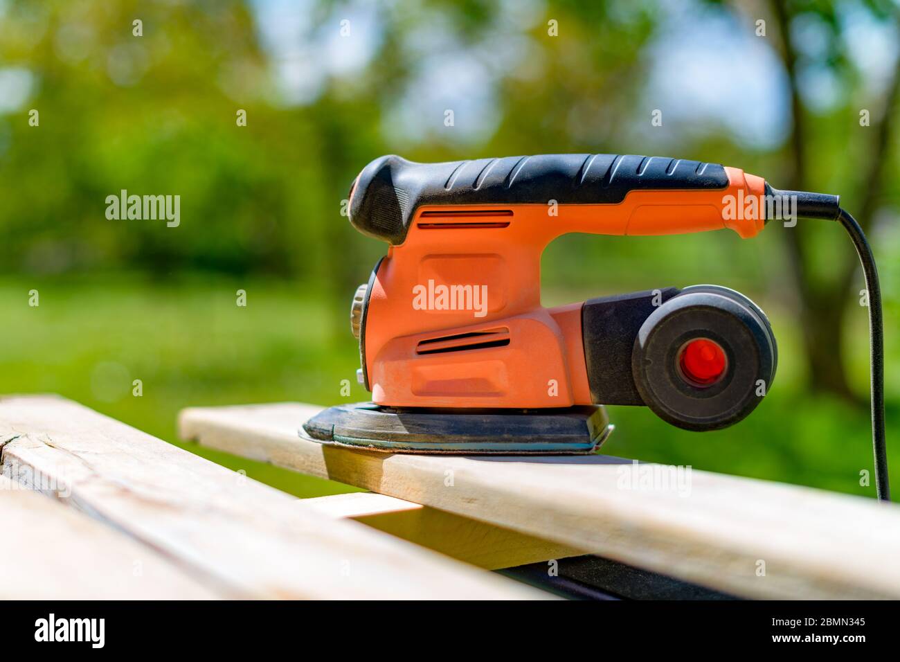 Wood sanding in the garden. DIY home improvement, restoration ...