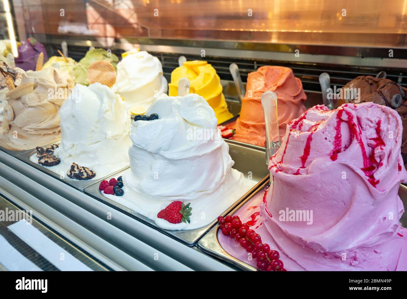 Assortment of ice cream at street shop. Ice cream in showcase fridge at ...