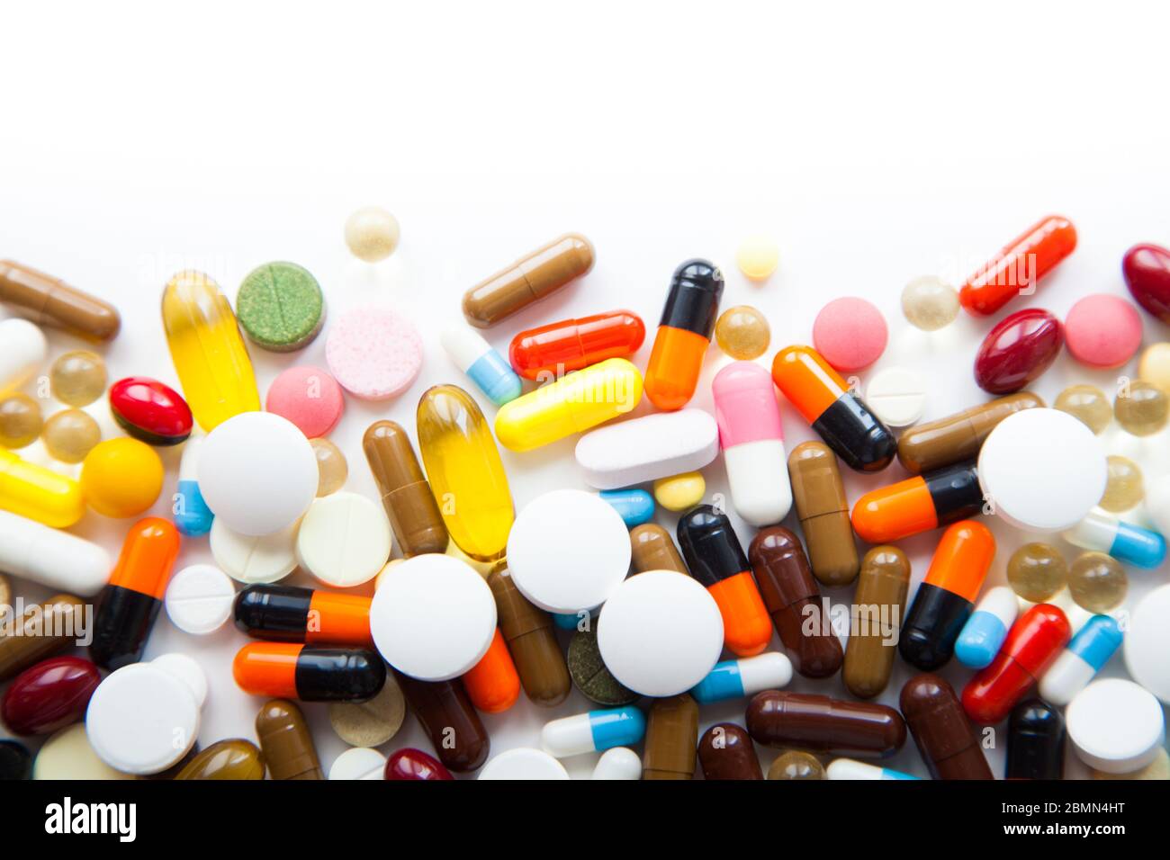 Color Pills are scattered over a white background with a copy of space ...