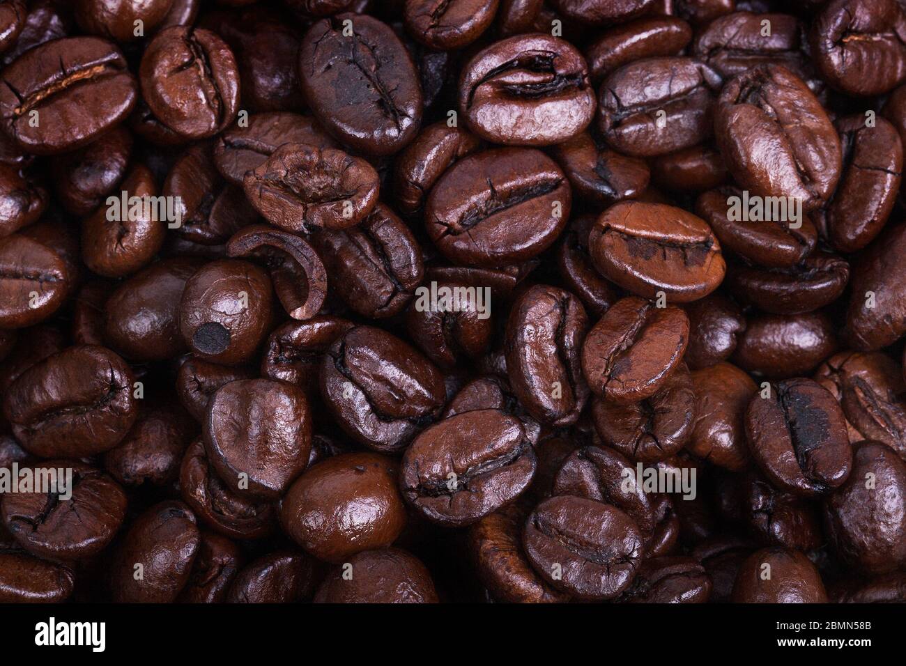 Dark roast coffee bean background Stock Photo - Alamy