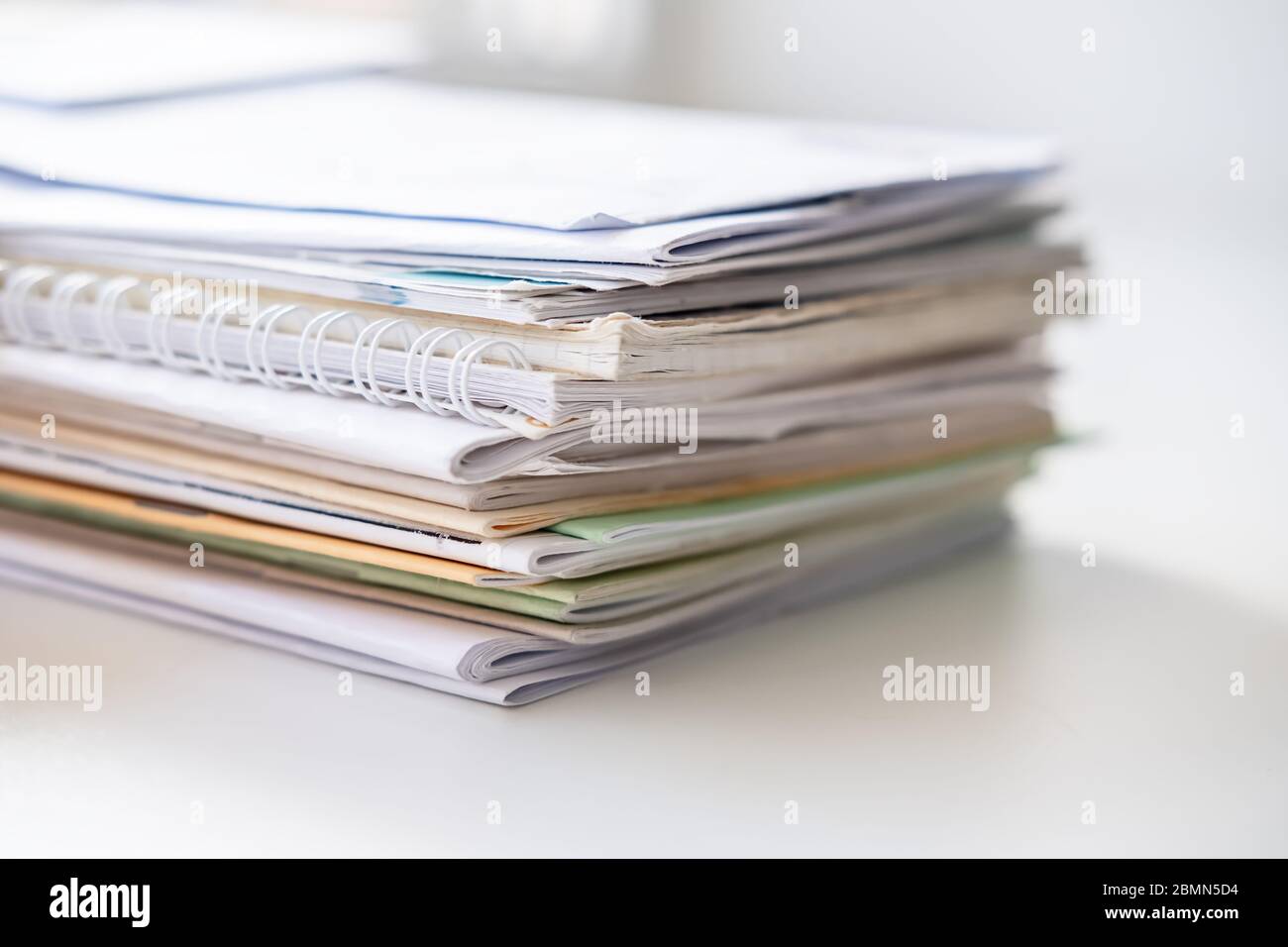 Pile of different notebooks on a white windowsill, in natural light ...