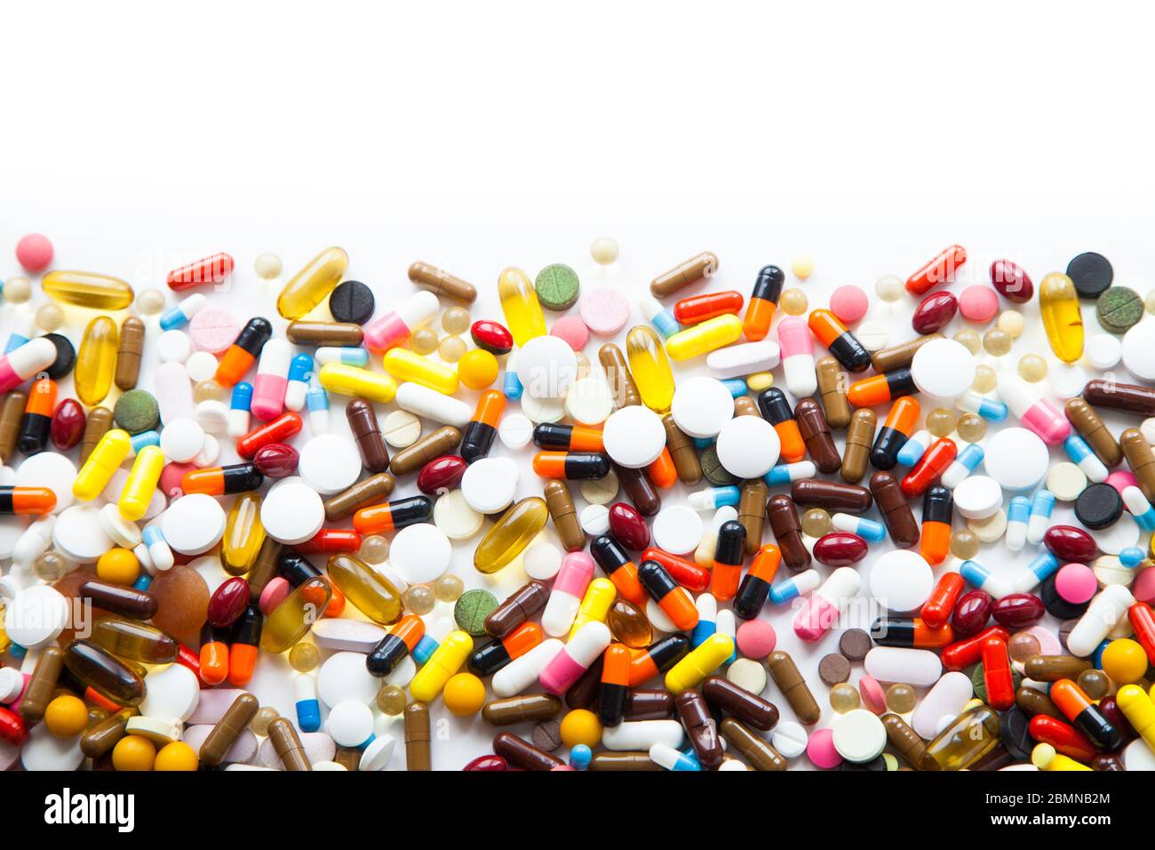 Color Pills are scattered over a white background with a copy of space ...