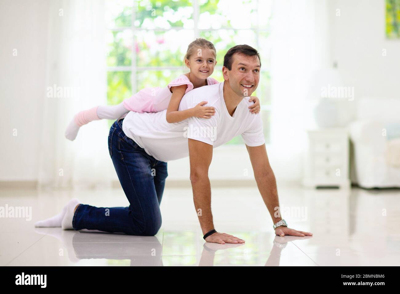 Father and daughter in baby ballet studio. Dad playing with little ...