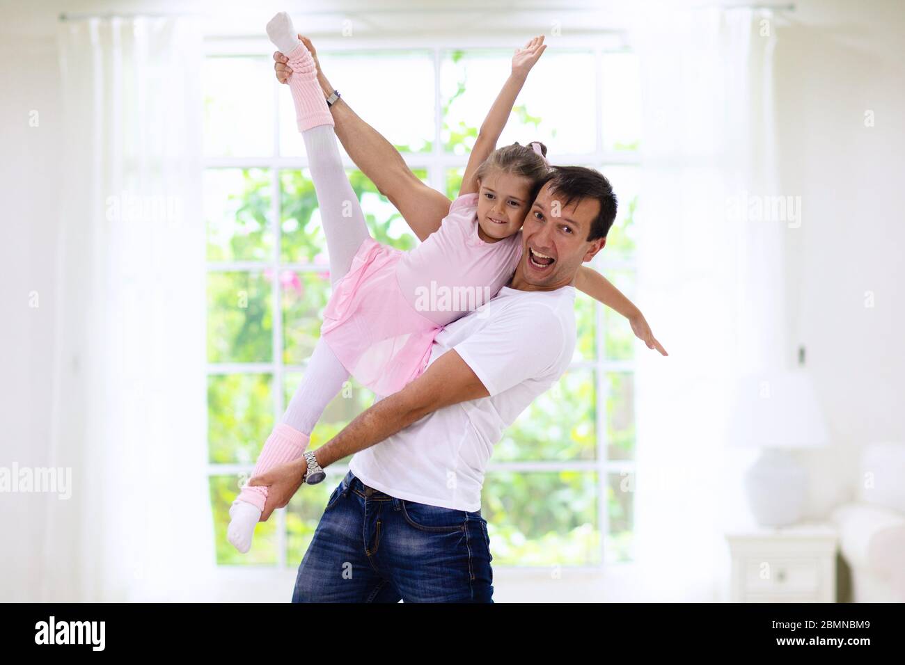 Father and daughter in baby ballet studio. Dad playing with little ...