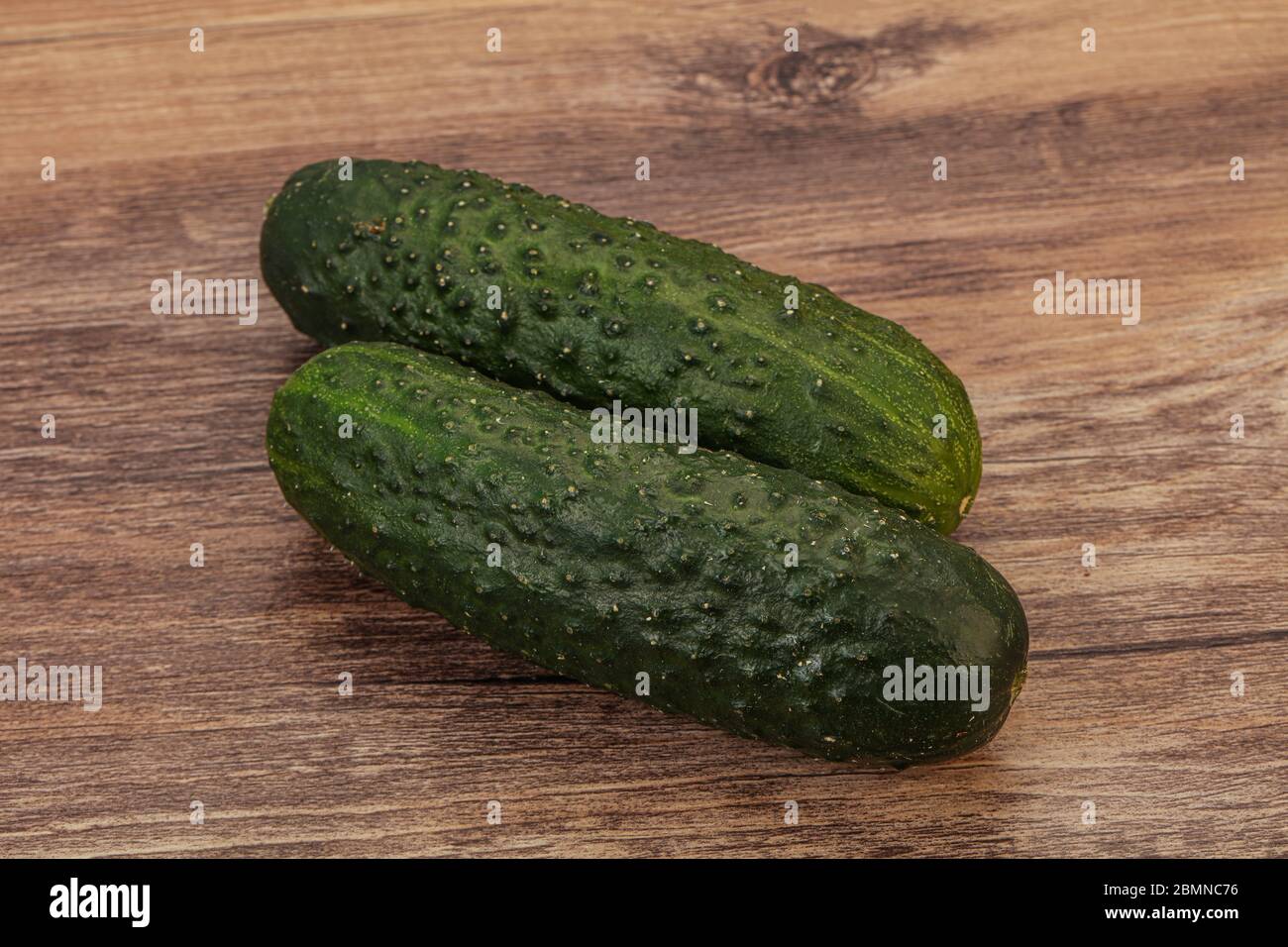 Green fresh two cucumbers over background Stock Photo - Alamy