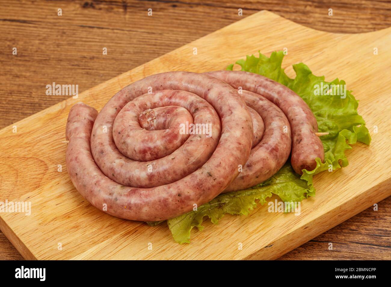 Raw pork sausage ring for grill Stock Photo - Alamy