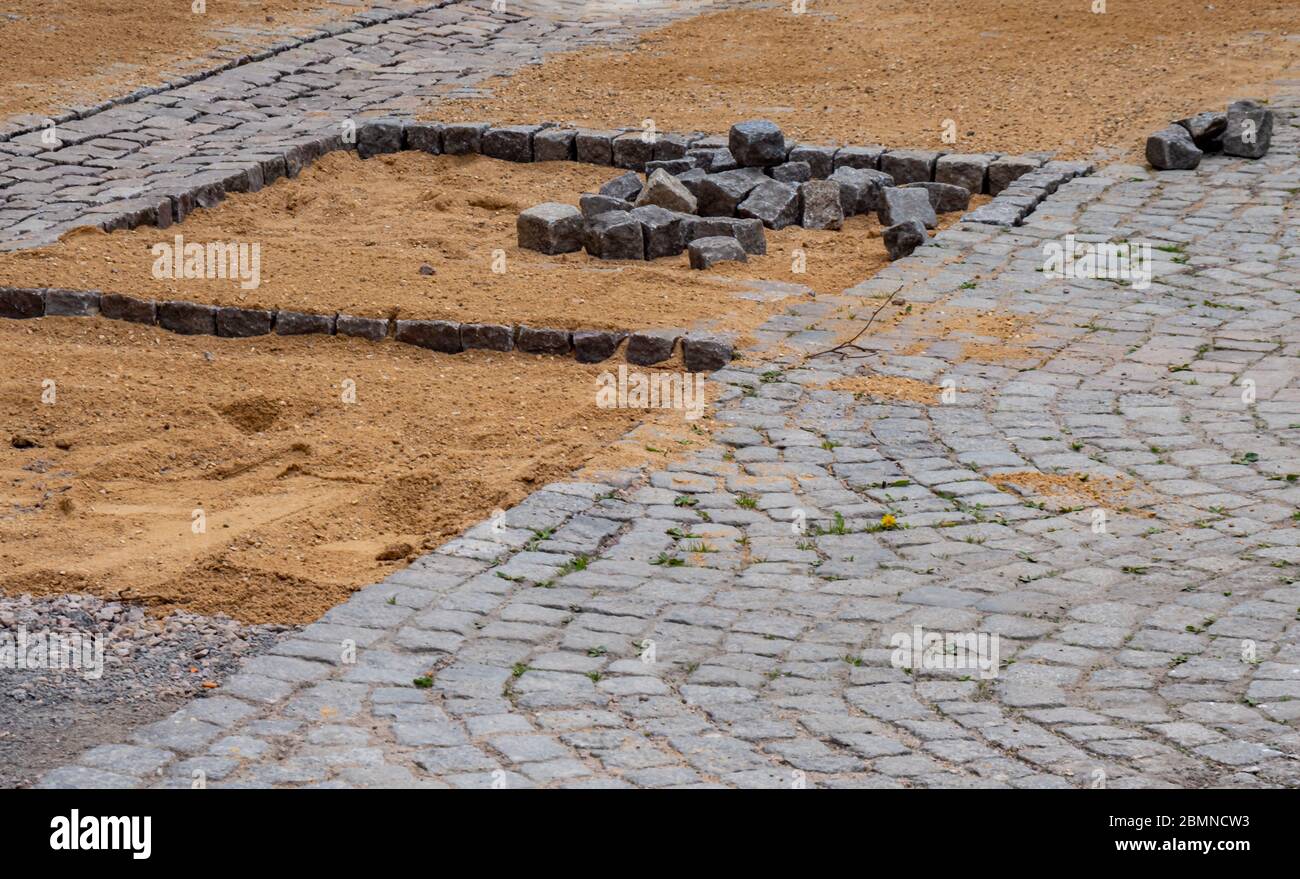 Paving stones old town path construction sand Stock Photo - Alamy