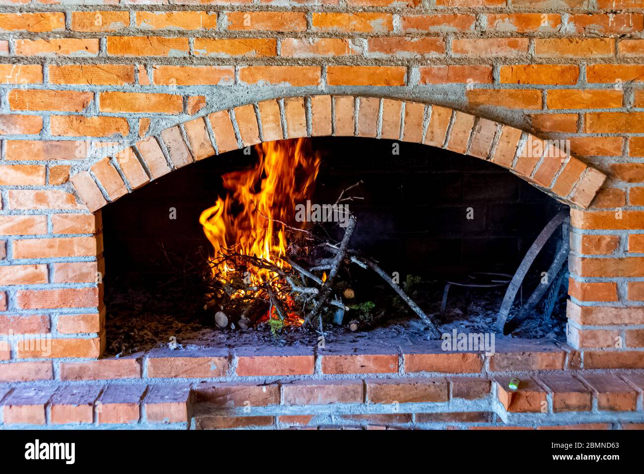 Branches are burning inside fireplace made of bricks Stock Photo - Alamy