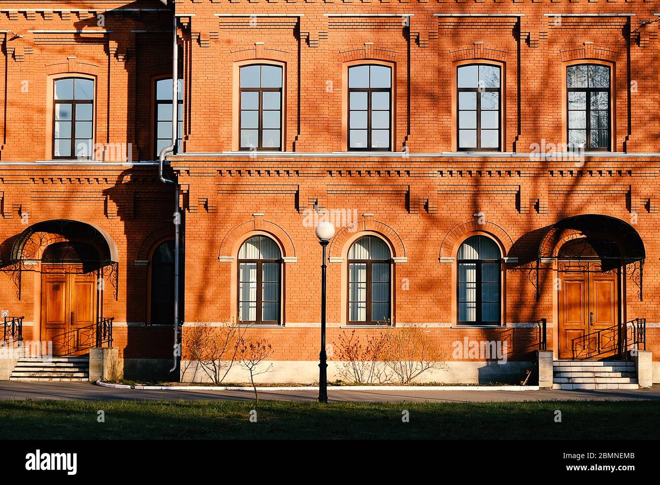 Two main entrances to the house. The facade of a red brick building in ...