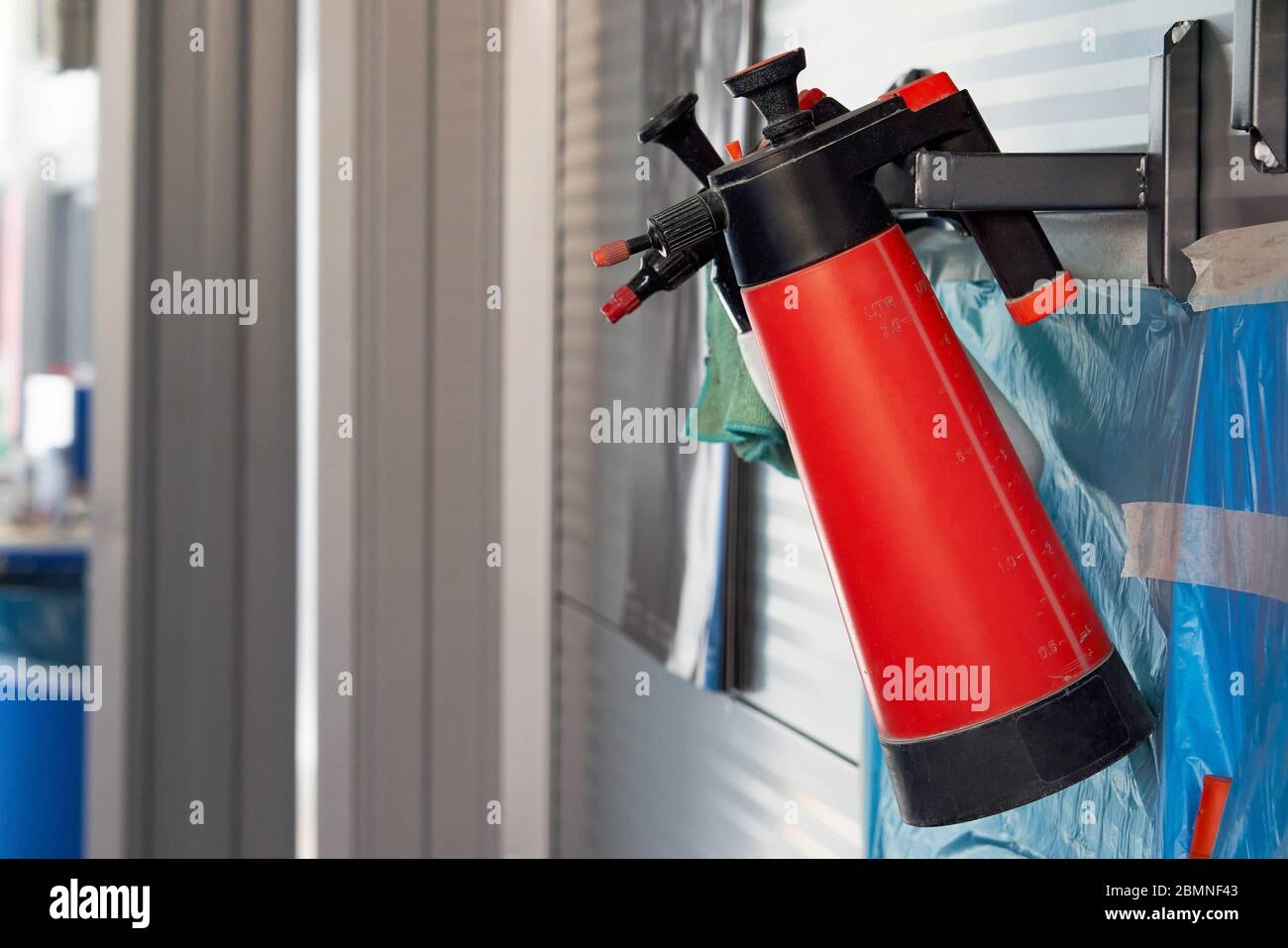 Plastic bottles with car spray hanging on the wall in auto repair shop ...