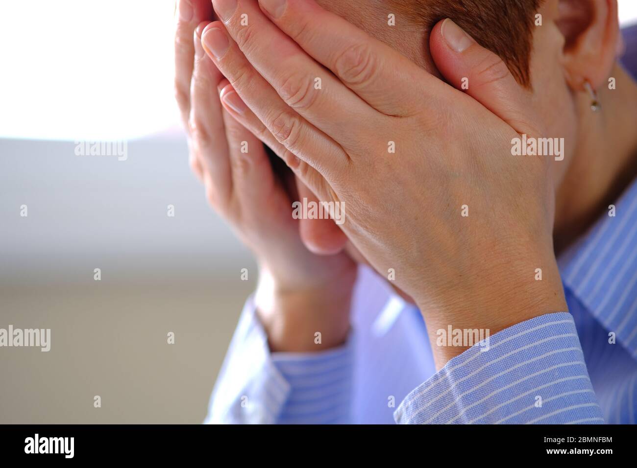 The woman covered her face with her hands. Lose his job. Crying after ...