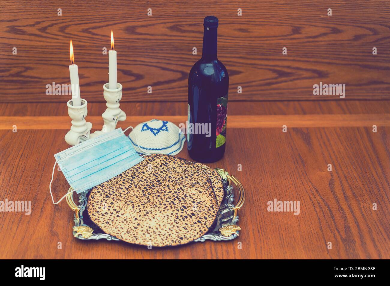Corona Passover. Dust mask, bottle of wine and matzah - a traditional ...