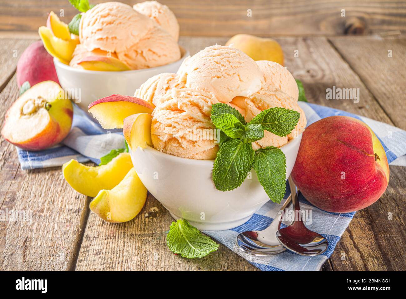 Homemade sweet peach ice cream. Peach gelato balls in small bowls, on ...
