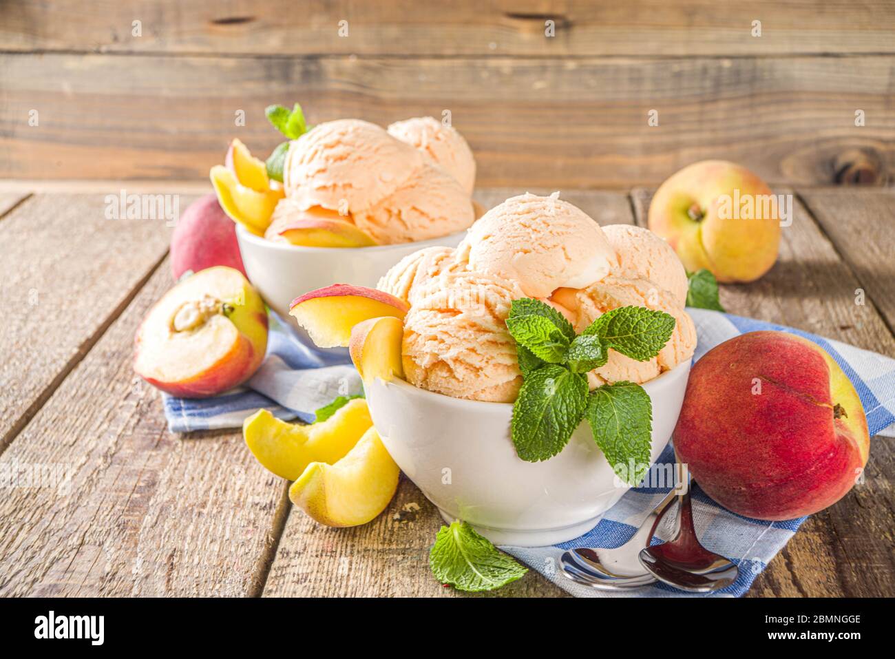 Homemade sweet peach ice cream. Peach gelato balls in small bowls, on ...