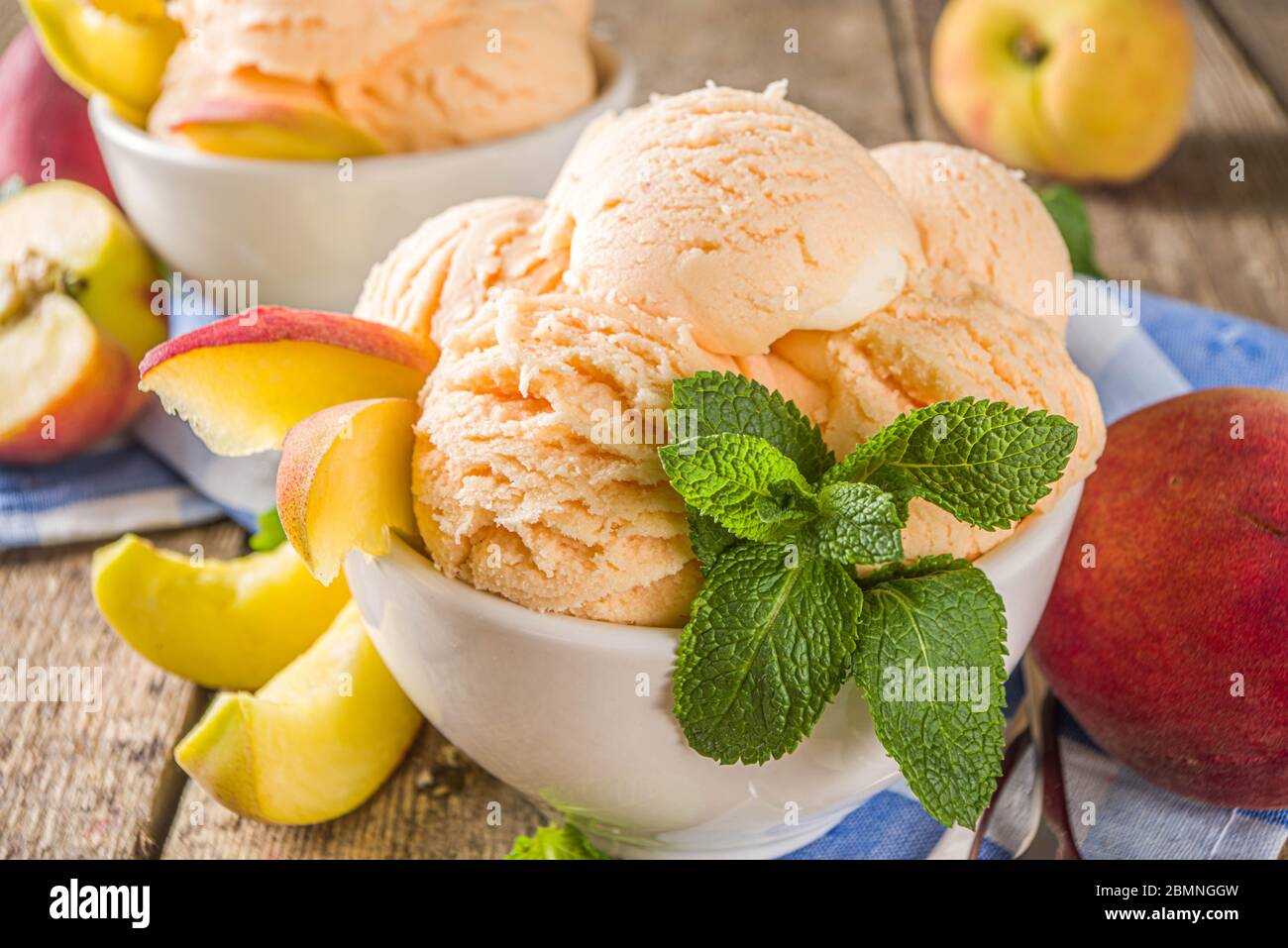 Homemade sweet peach ice cream. Peach gelato balls in small bowls, on ...