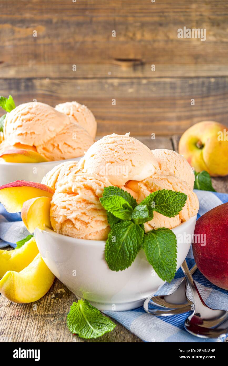 Homemade sweet peach ice cream. Peach gelato balls in small bowls, on ...